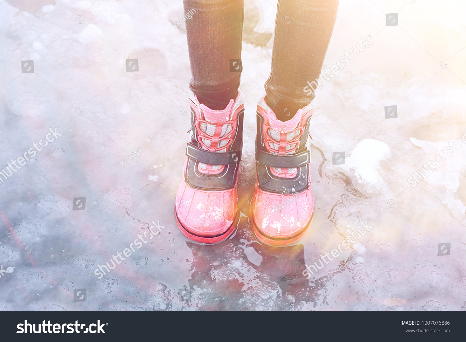 winter children's boots / rubber bright children's shoes on the street ...