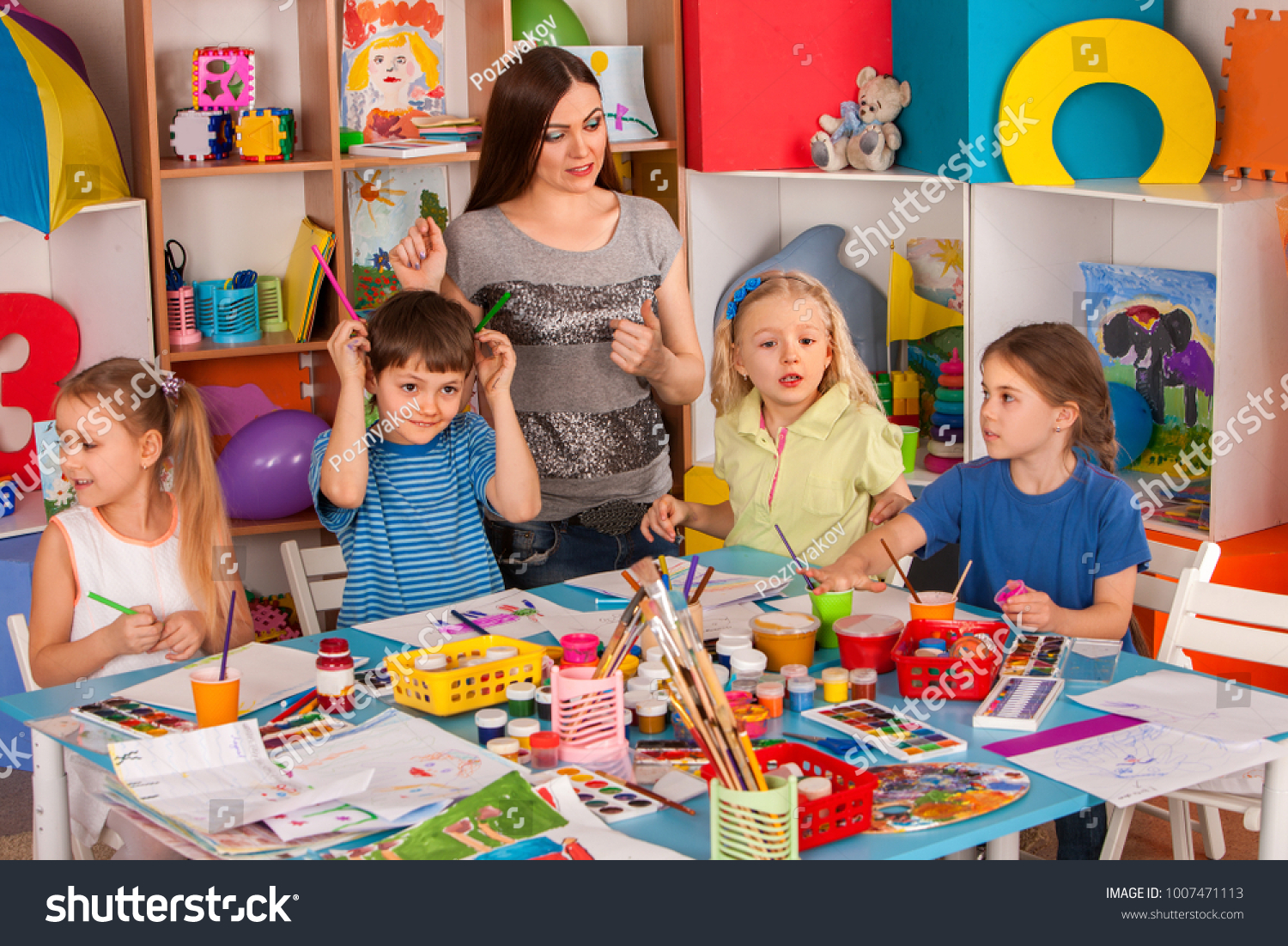Kids playroom organization of children painting and drawing in kid's club. Craft lesson in ...