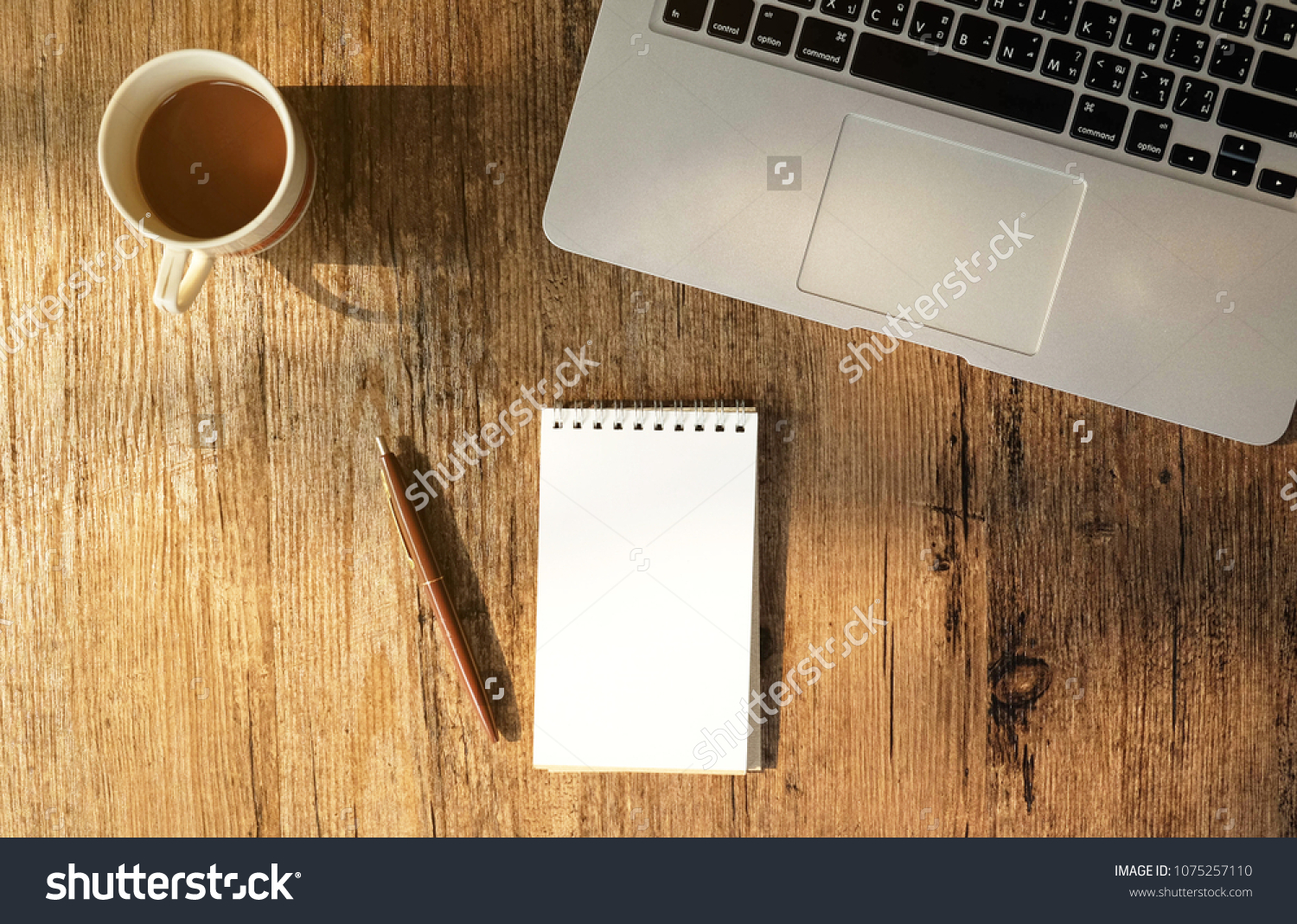 Office desk with laptop coffee notebook and pen. Top view with copy ...