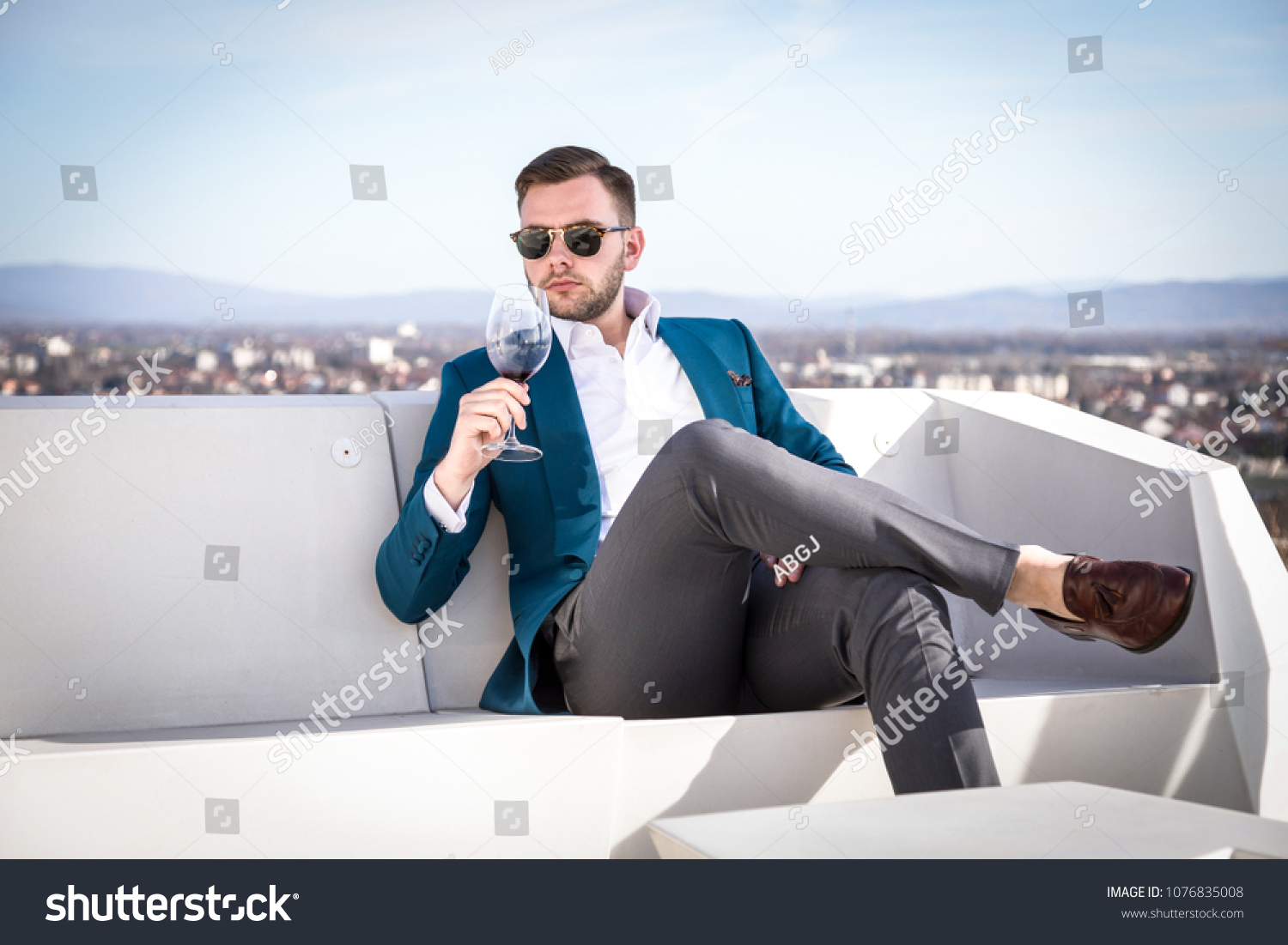 Man millionaire in expensive custom tailored suit sitting outdoors with ...