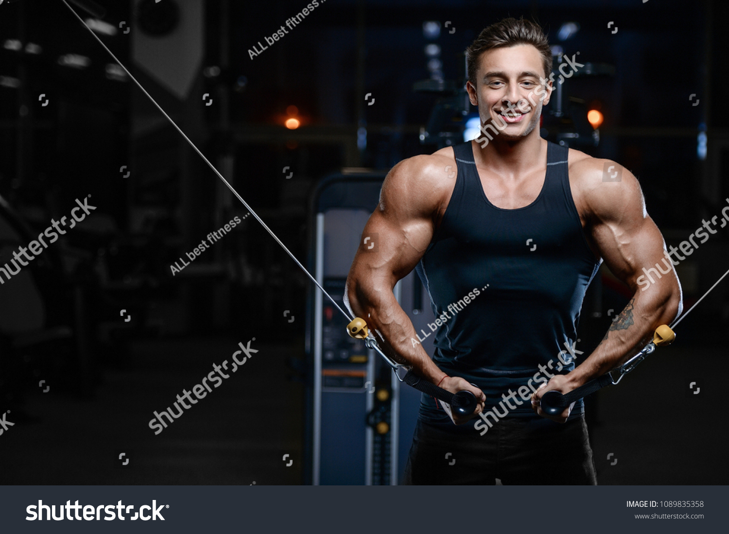 Handsome young fit muscular caucasian man of model appearance workout training in the gym ...