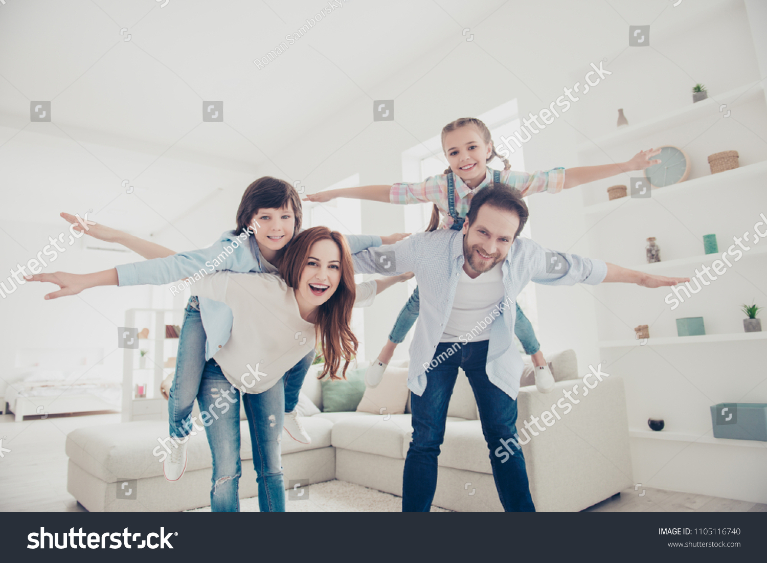 Low angle bottom view of creative joyful family parents holding on back ...