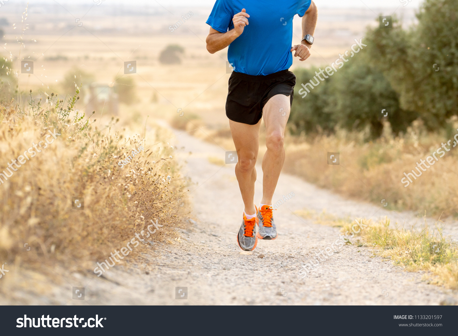 close up man runner legs and feet of extreme cross country man running ...