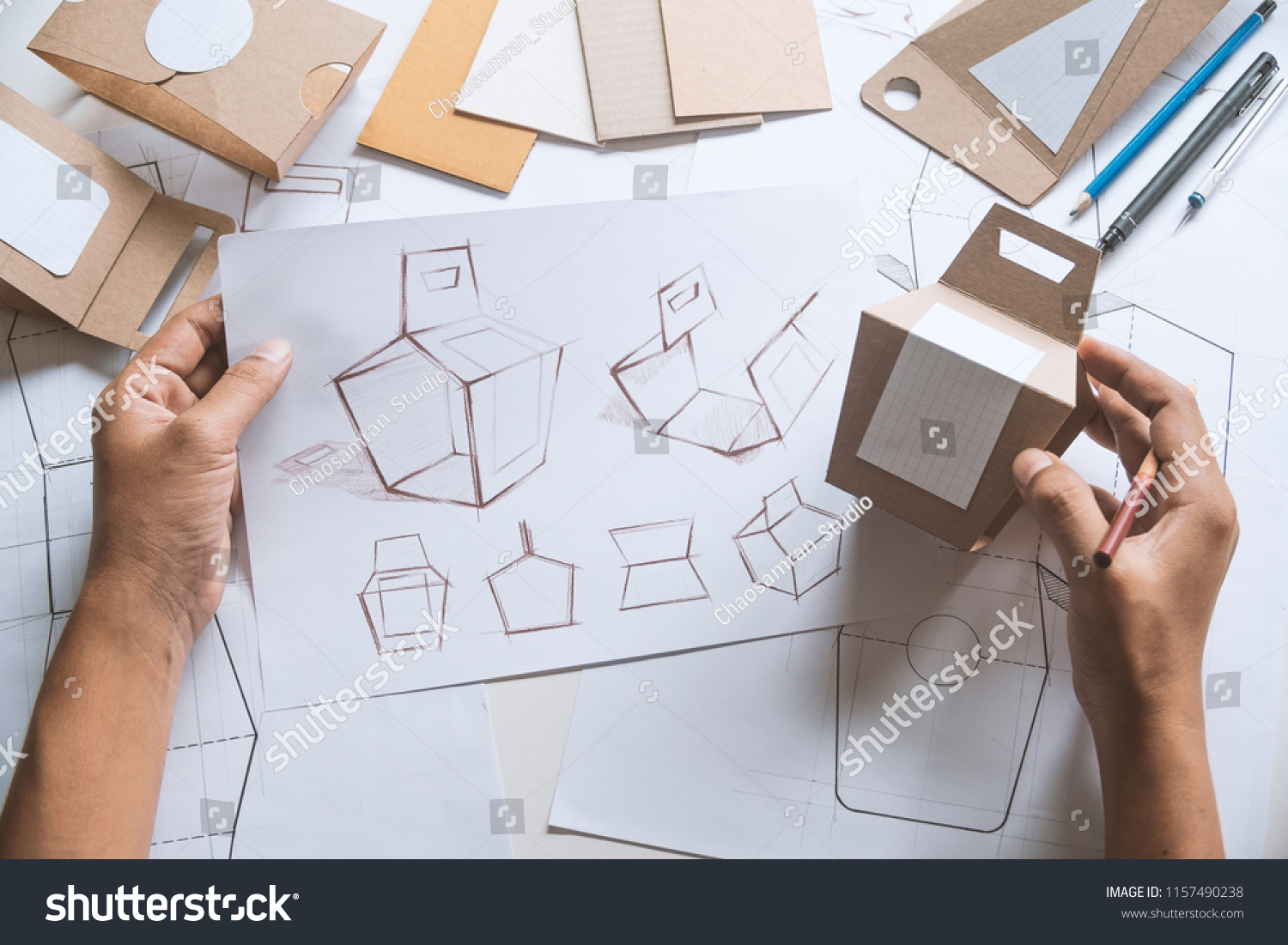 Designer sketching drawing design Brown craft cardboard paper product ...