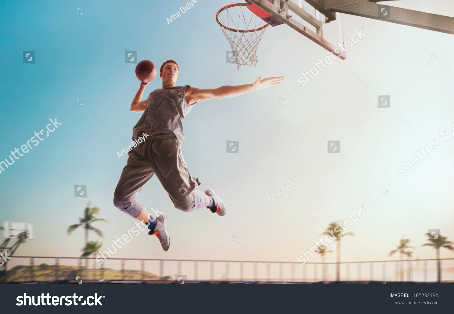 Streetball. Basketball player in action on sunset. Basketball players ...