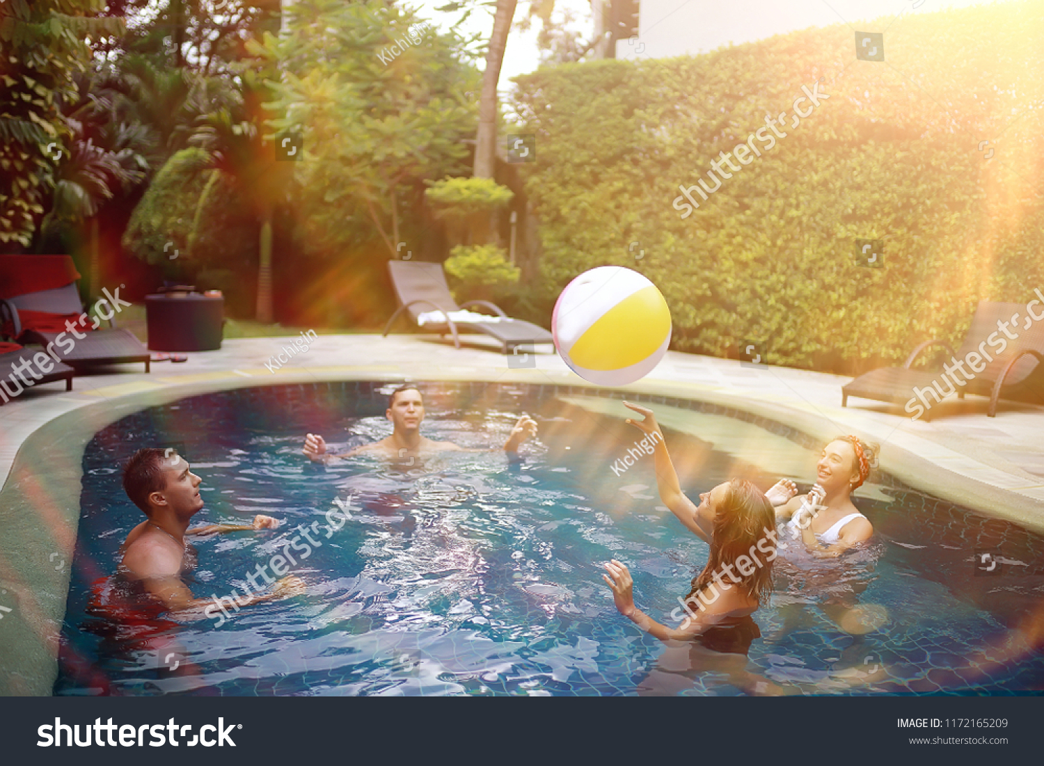 friends have fun in the summer pool at the hotel / cheerful company of ...