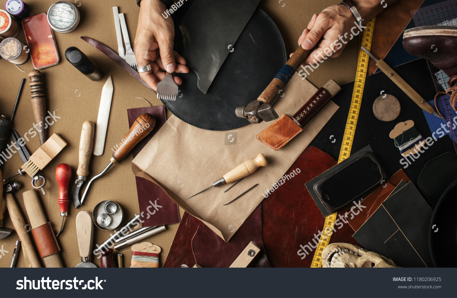 Close up of leather designer hands making custom made shoes working ...