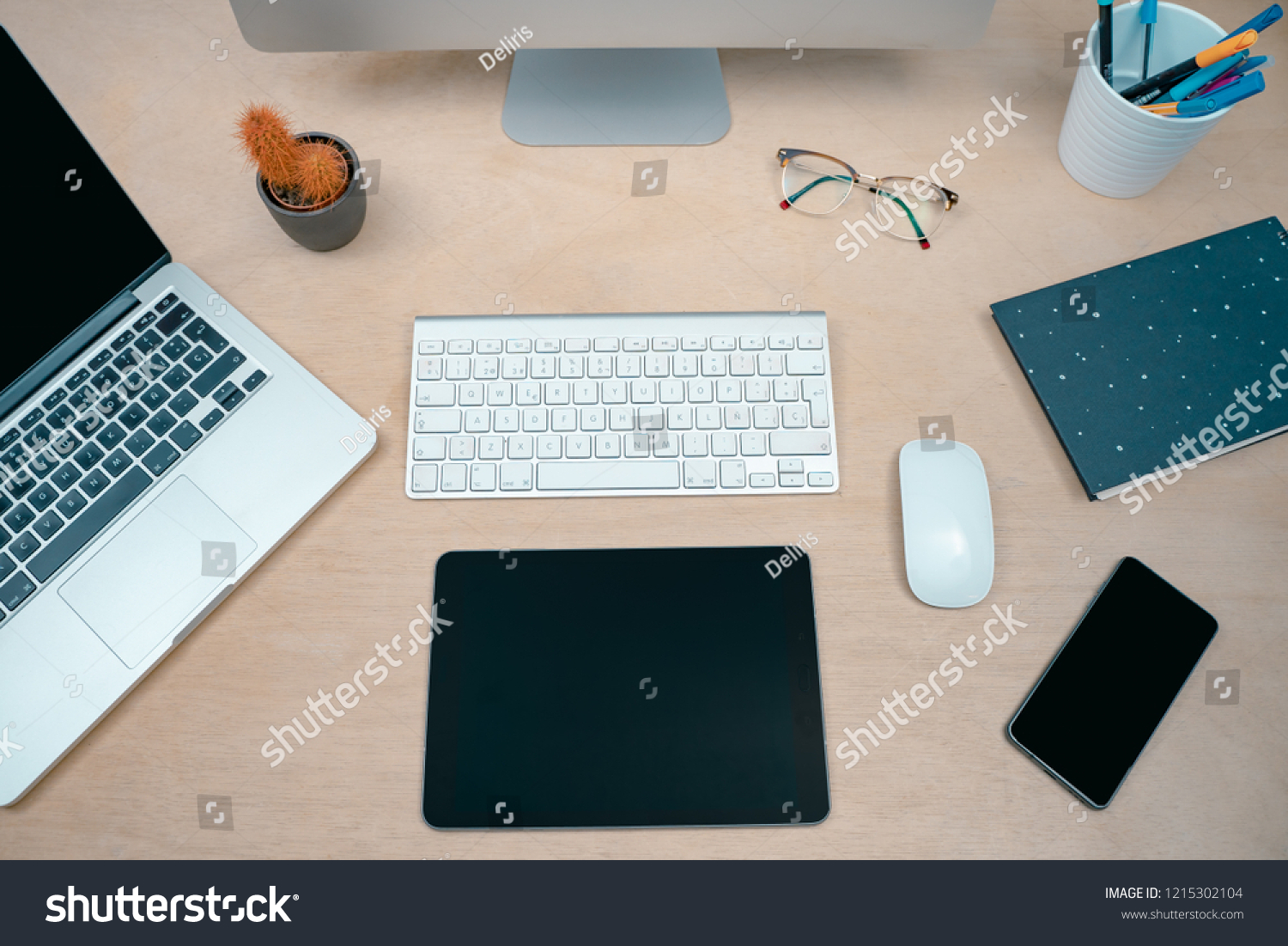 Top view office desk table with supplies and gadgets on a wooden table ...