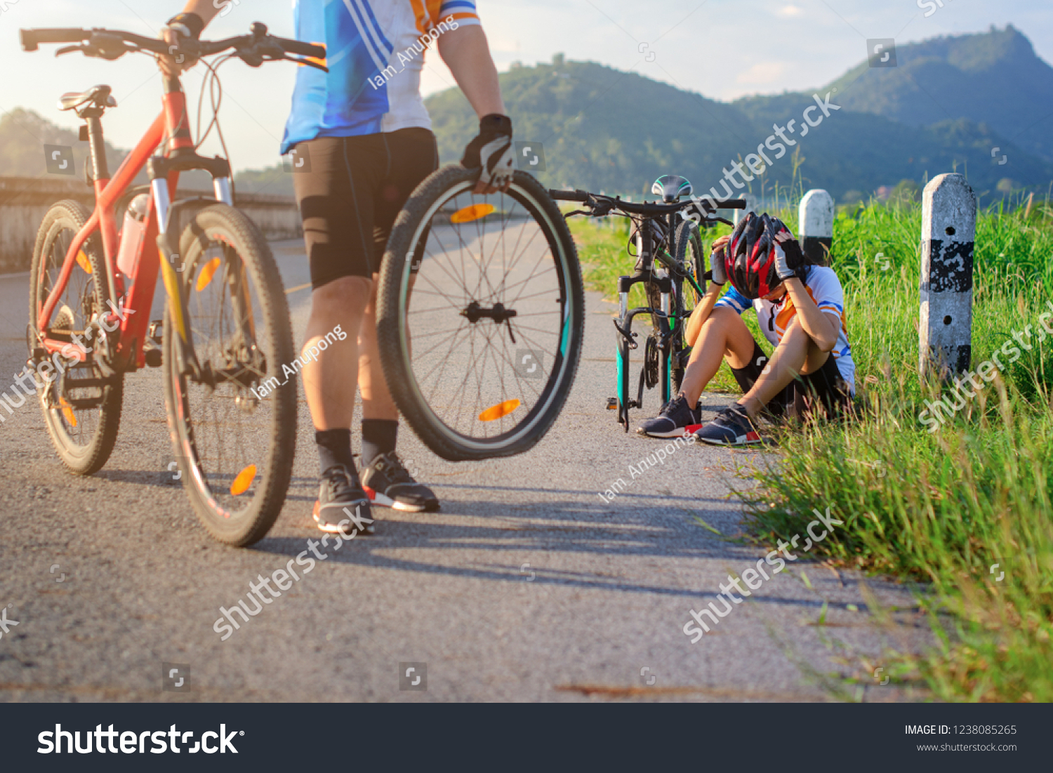woman cycling has a problem during the way needs flat tire repairing ...