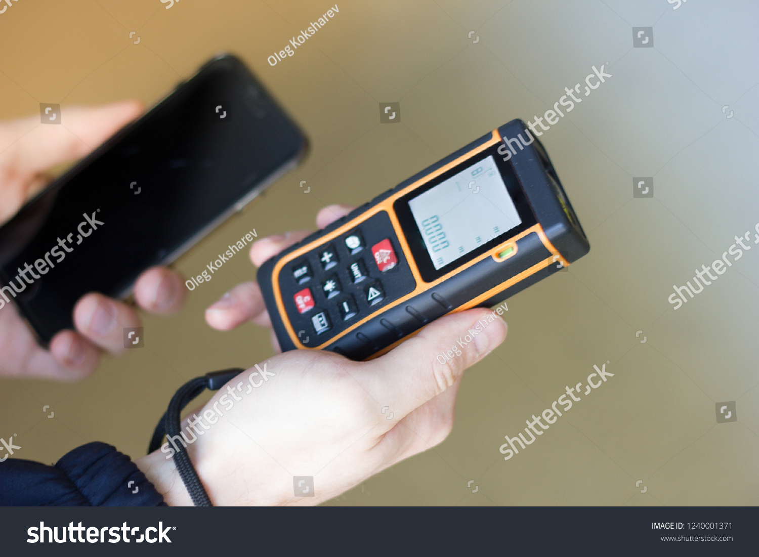 The measuring device in the form of a laser rangefinder in the hands of ...
