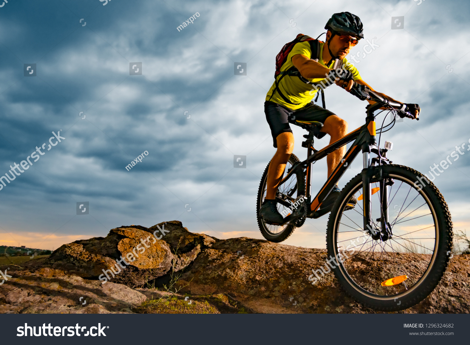 Cyclist Riding the Mountain Bike on the Rocky Trail at Sunset. Extreme Sport and Enduro Biking ...