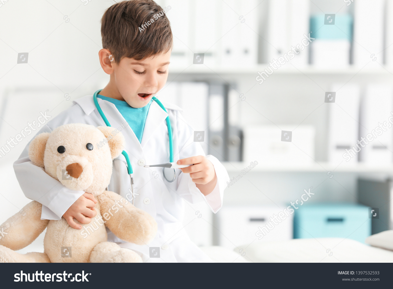Cute little boy dressed as doctor playing with toy bear in hospital_站酷海 ...