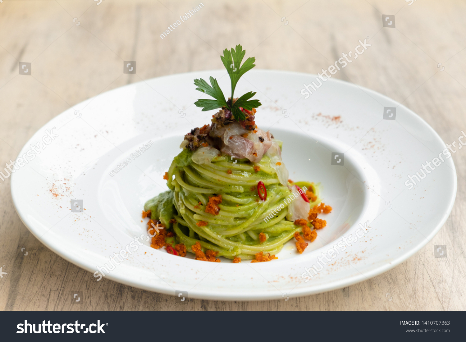 close up of a colourful green spaghetti seafood pasta fish carpaccio ...