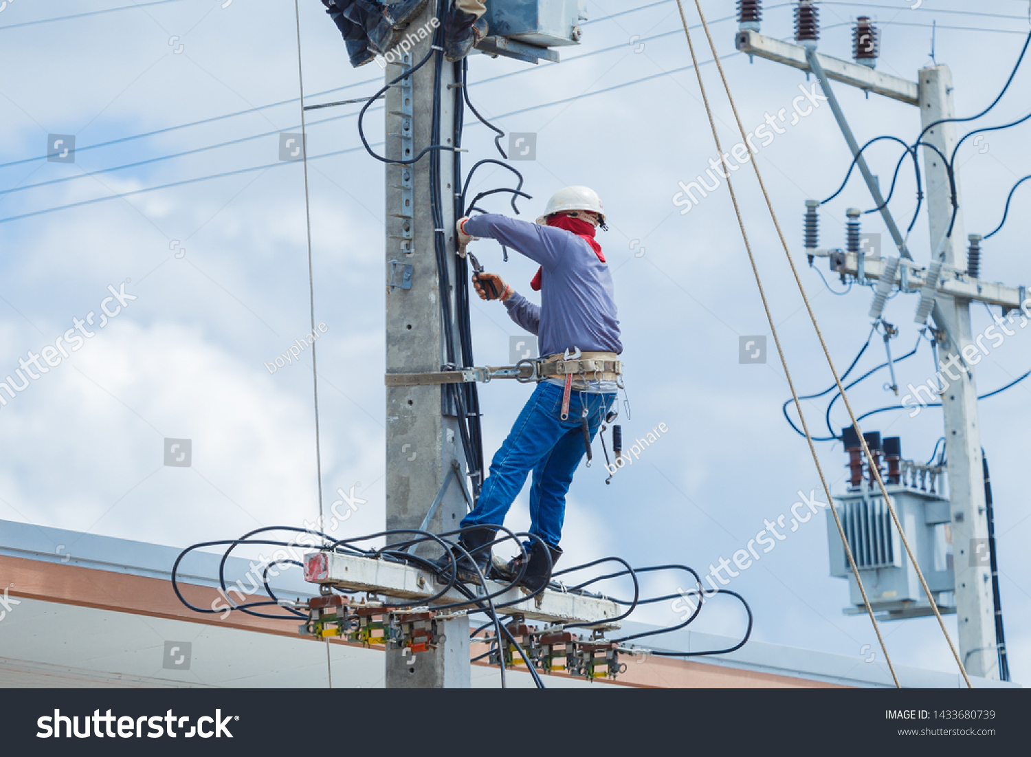 Electricians Wiring Cable repair services worker in crane truck bucket ...