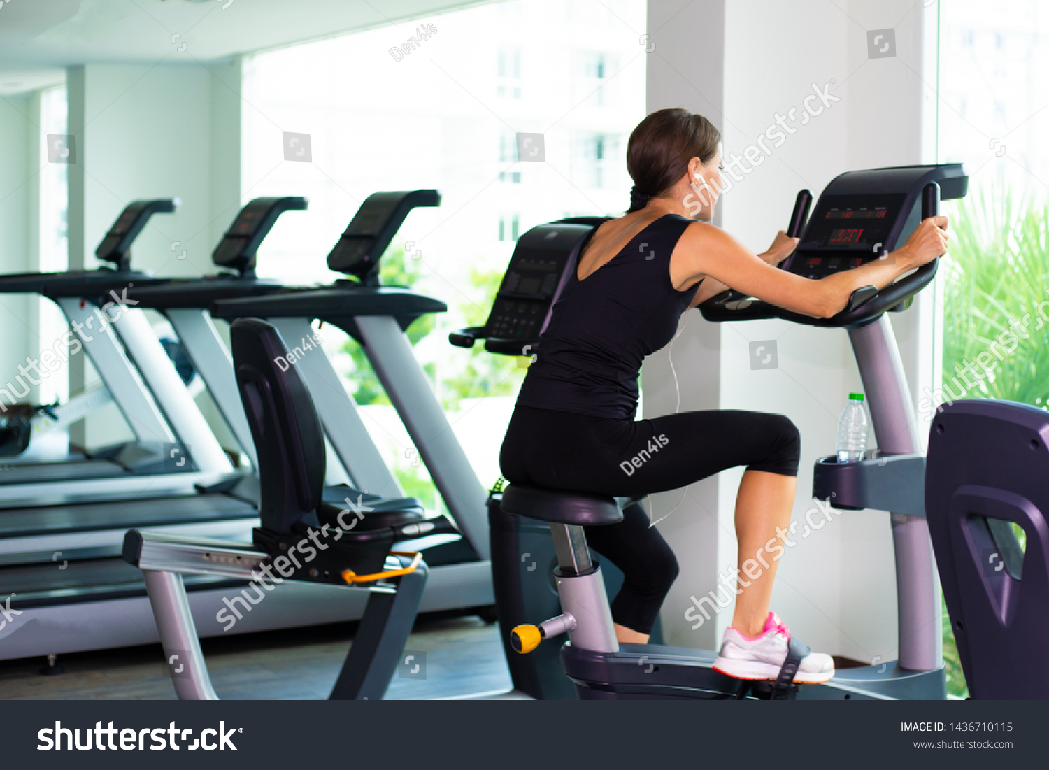 girl in black sport wear vigorously works on exercise bike back view_站酷 ...