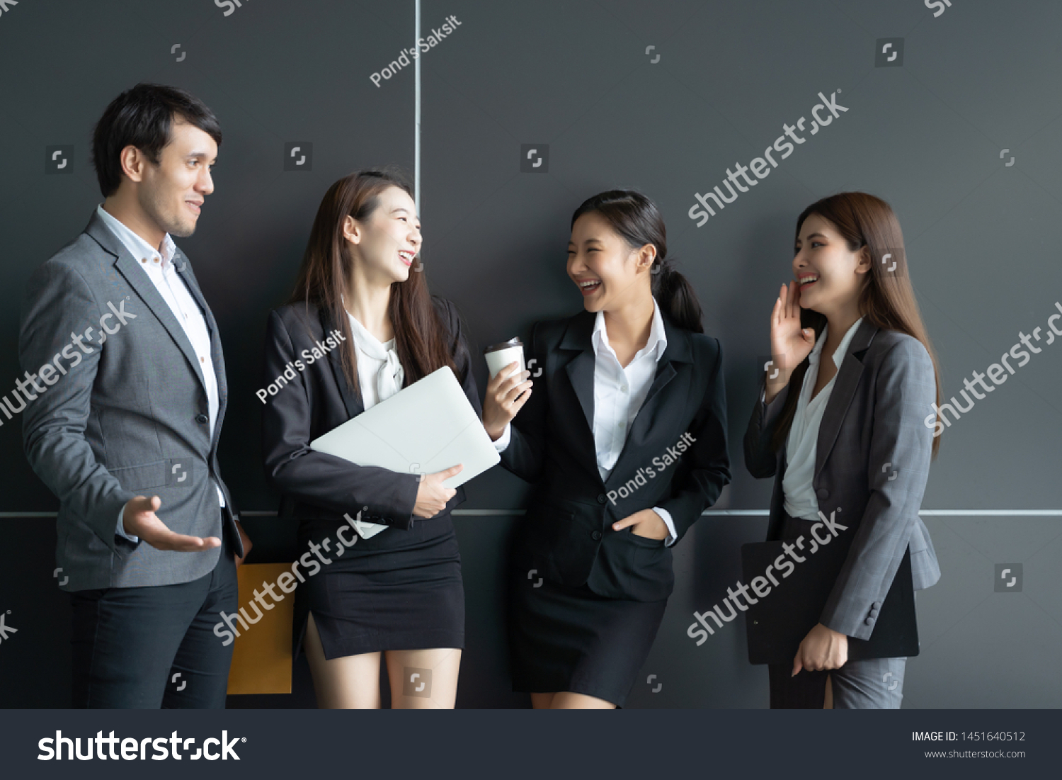 Asian business people discussion front of office building. Young businessman and businesswoman ...