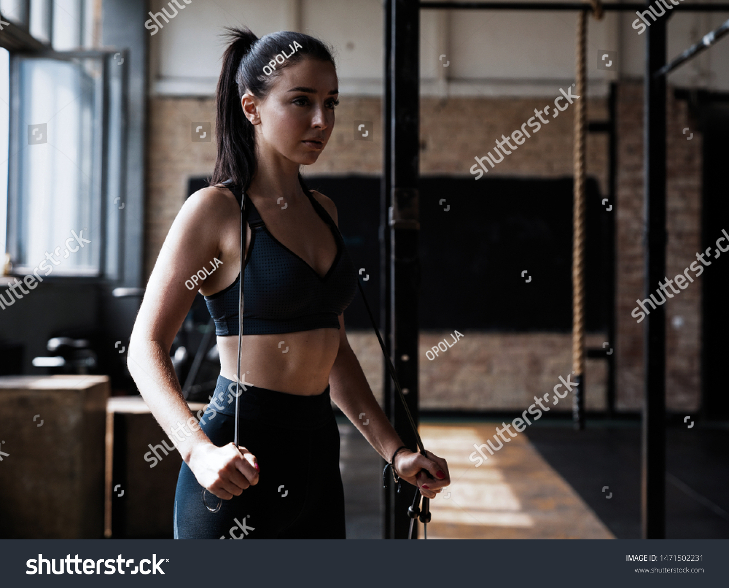 Fit and healthy woman standing at gym with skipping rope. Sportswoman resting after workout_站酷海洛 ...