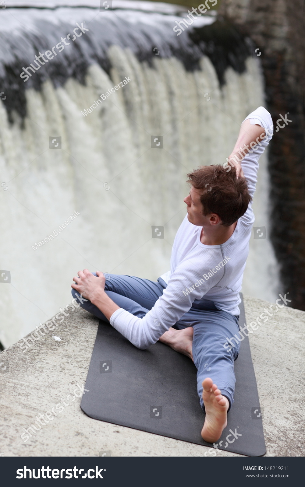 young fit man practicing stretching over waterfall - outdoor_站酷海洛_正版图片 ...