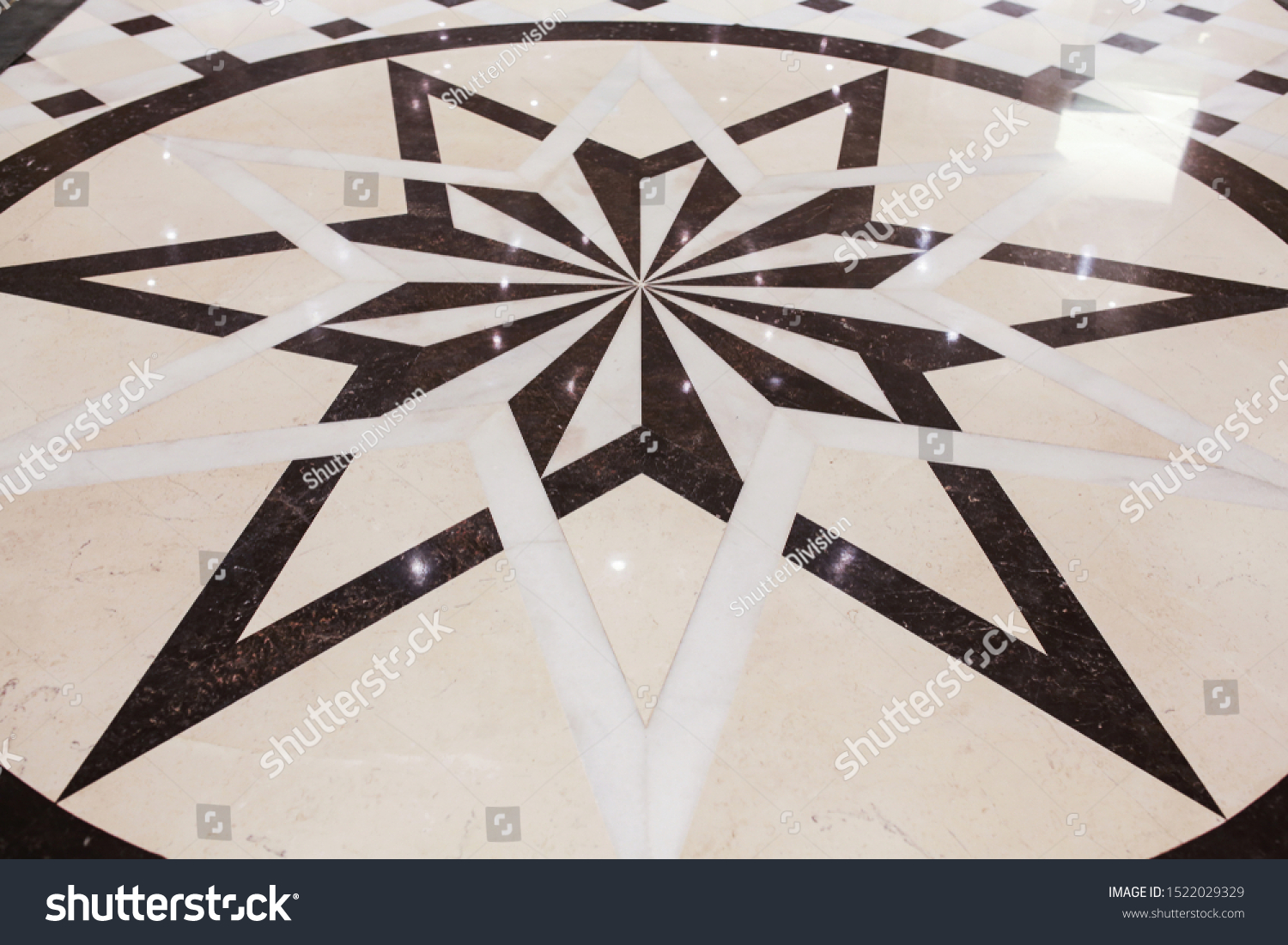 Close up of a star shape decorated pavement with black white and beige ...