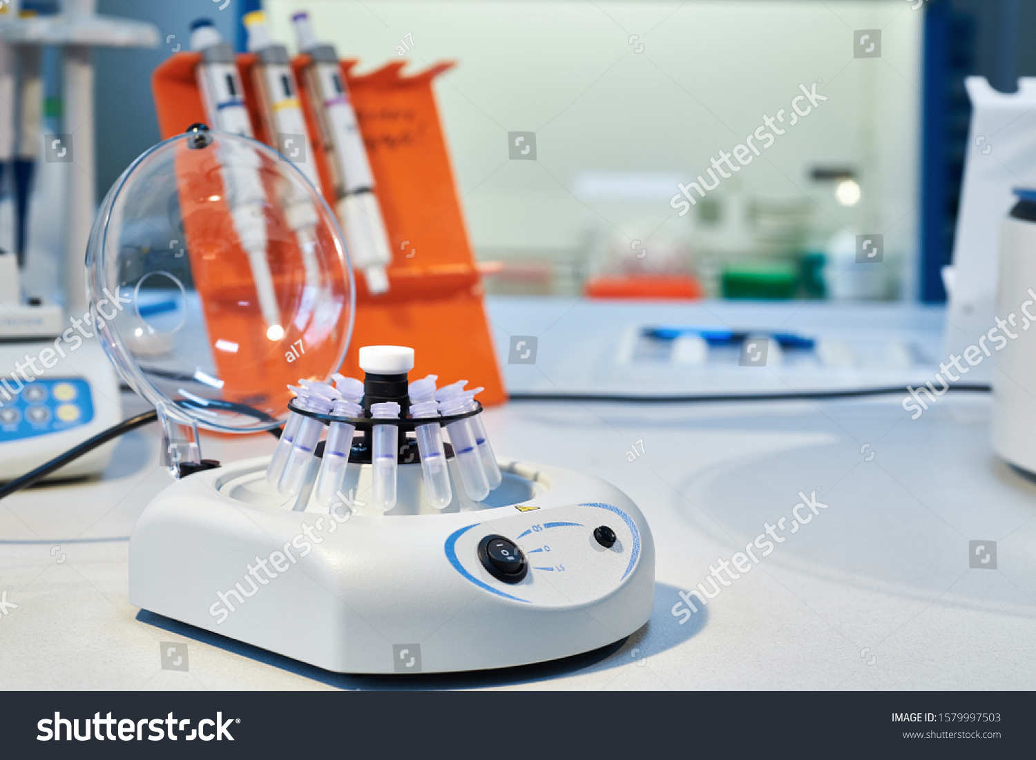 Close up of a chemist using a centrifuge rotor in lab for medical and scientific research. Close ...
