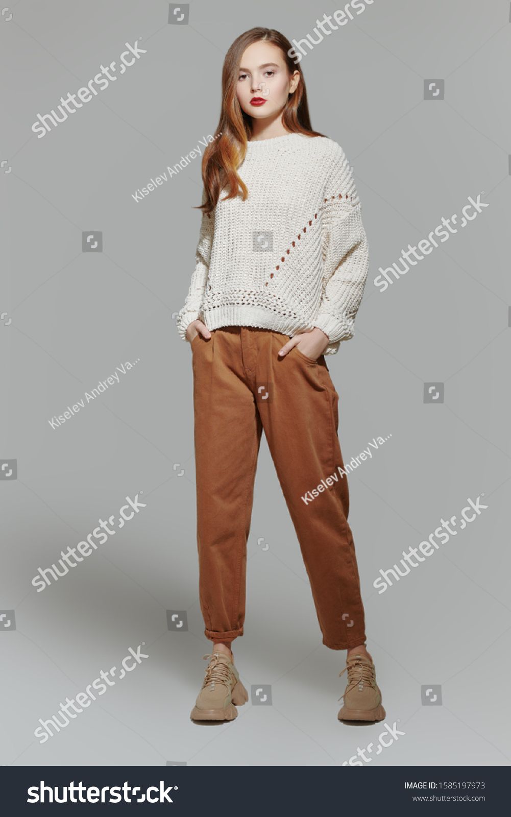 Fashion shot. Beautiful young girl in modern casual clothes posing at ...