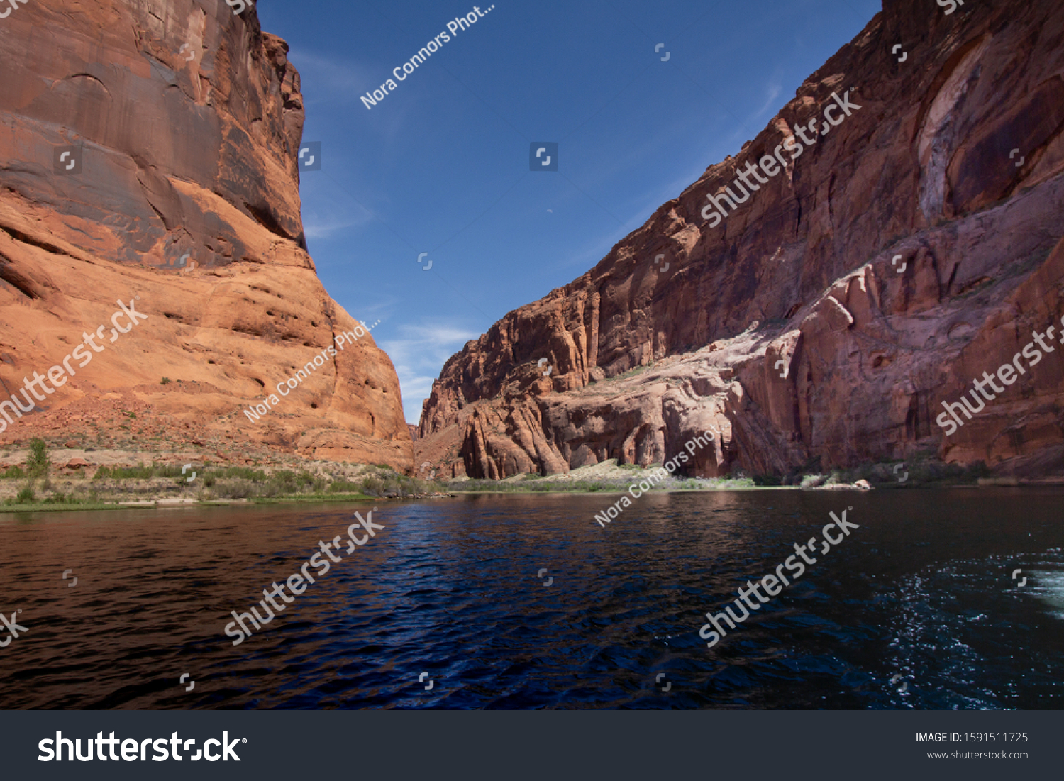 Boat ride on the serene Colorado River near Page Arizona on a bright ...