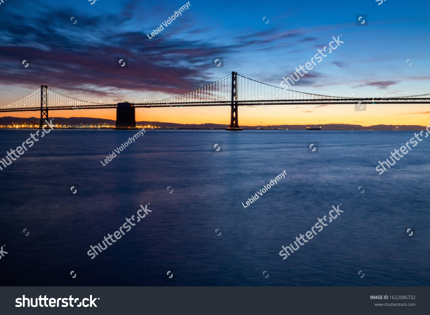 A beautiful sunrise by a mountain in California gives a silhouette to ...