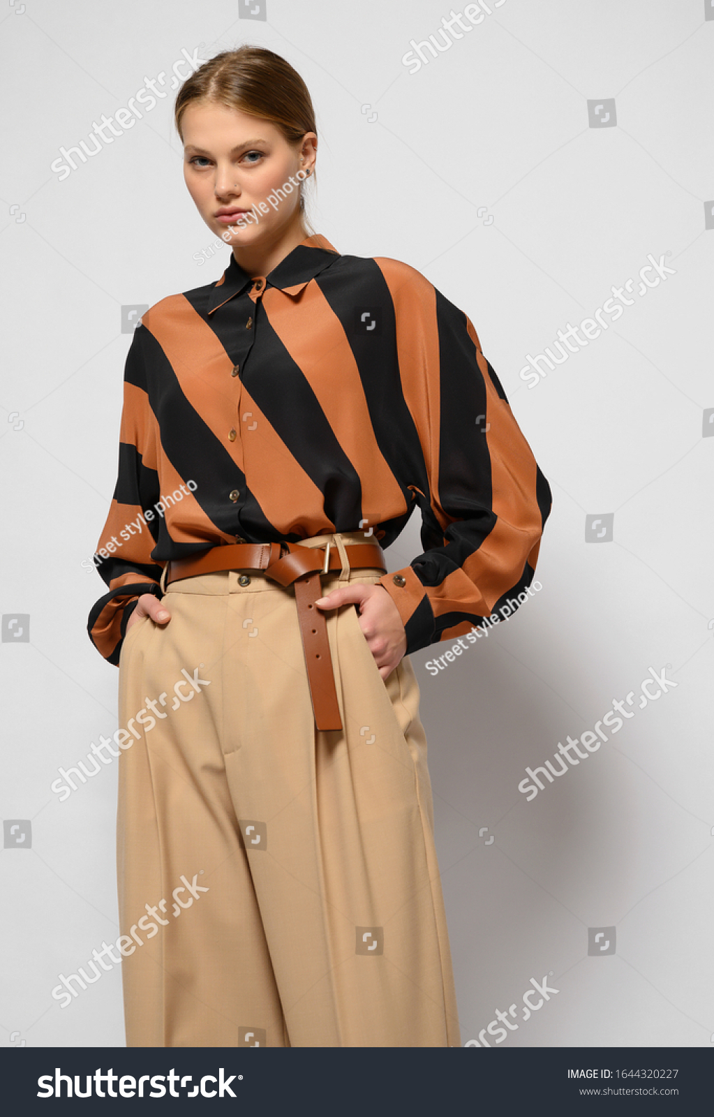 Fashion shooting in studio . Professional model fashionable clothes and ...