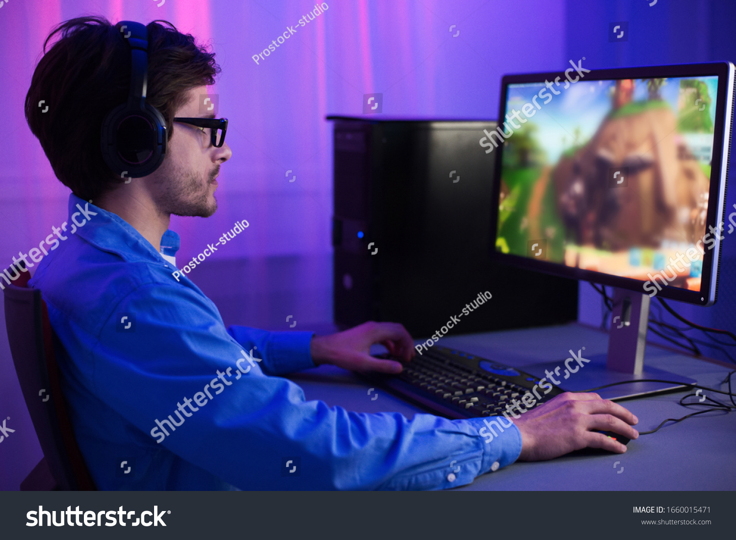 Online Gaming. Gamer Guy Playing Games Sitting At Desktop PC At Home At ...