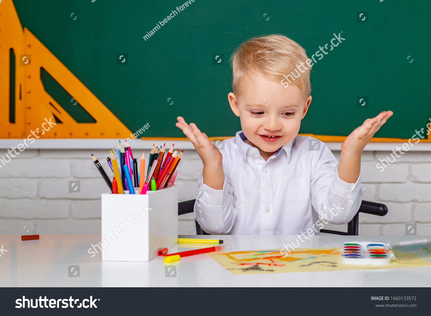 Little student boy happy with an excellent mark. Kid is learning in ...
