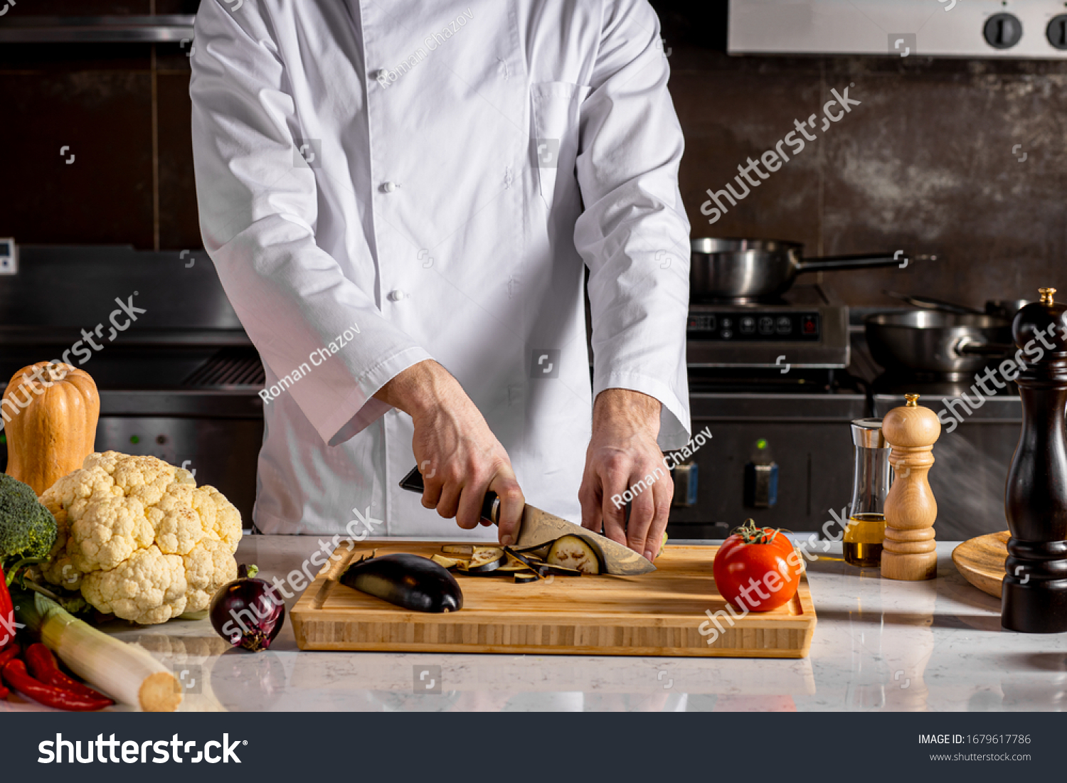 chef-cooker cut fresh vegetables on wooden board in kitchen professional cook work in restaurant ...