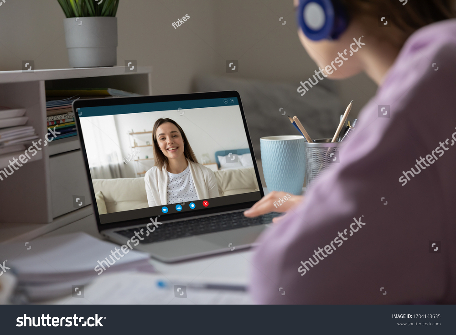 Pc screen view over woman shoulder two girls best friends chatting ...