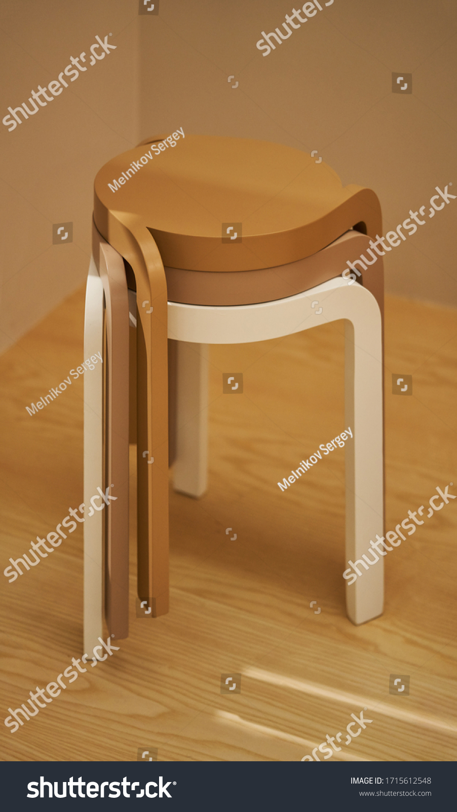 From above simple round stools stacked together and placed on wooden ...