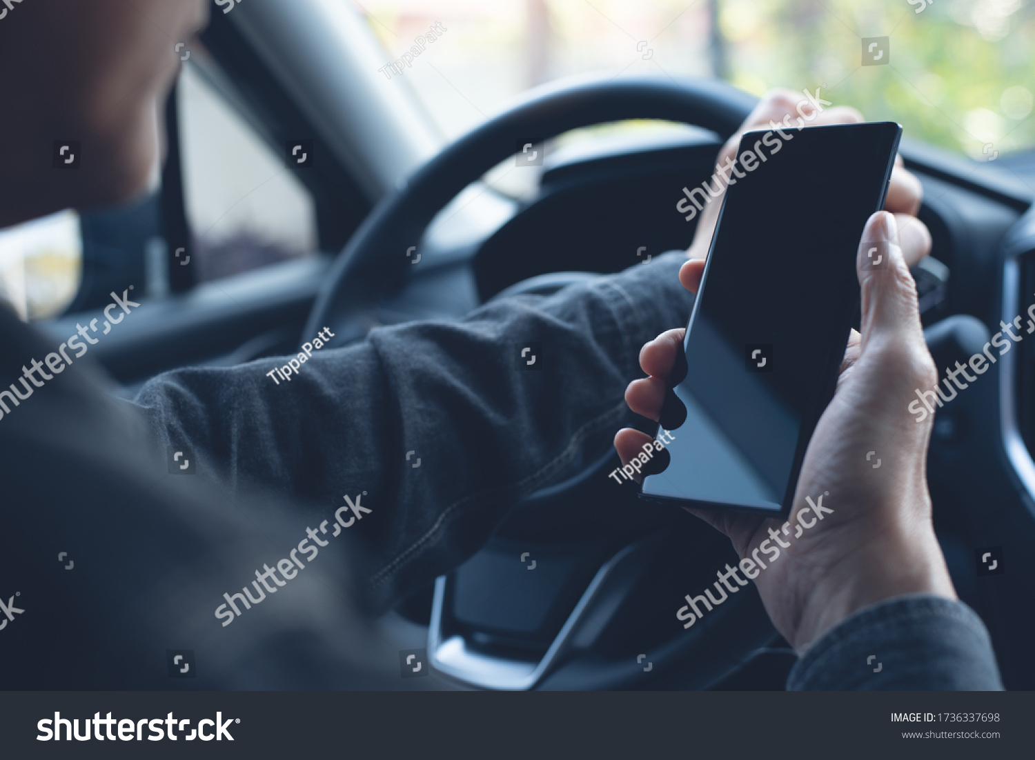 Mockup of man driver hand using blank black screen mobile smart phone ...