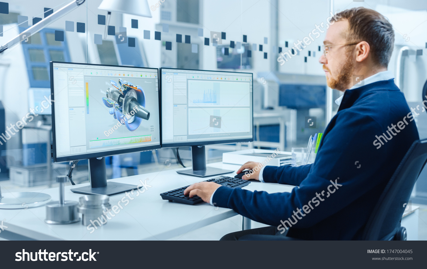 Industrial Engineer Working on a Personal Computer Two Monitor Screens ...