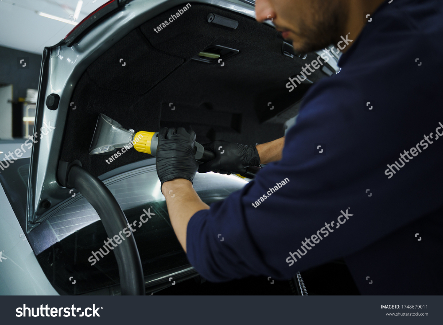 young man working on dry cleaning. car detailing. polishing. car wash ...