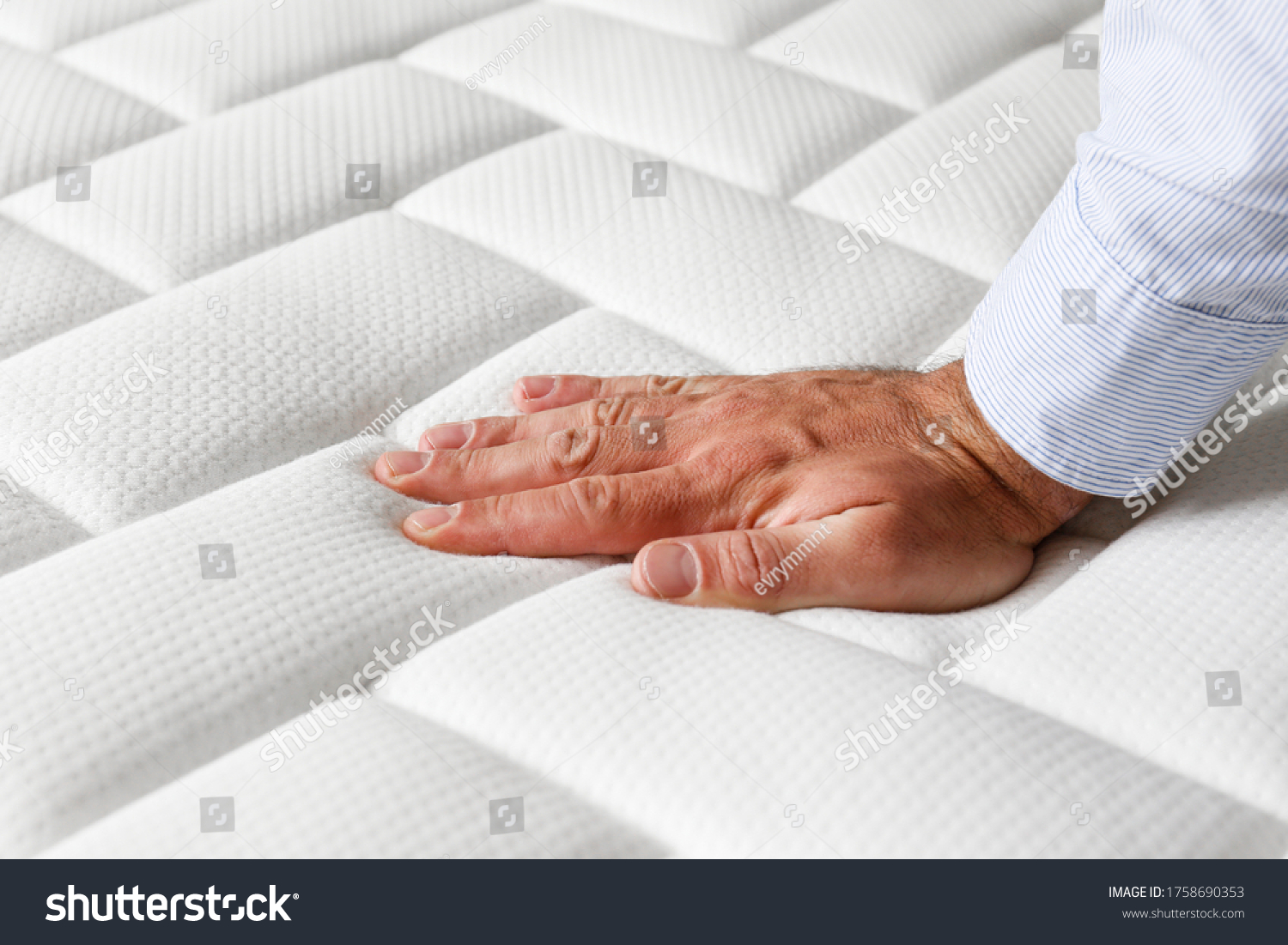 Cropped shot of man testing white orthopedic matress on firmness. Male ...