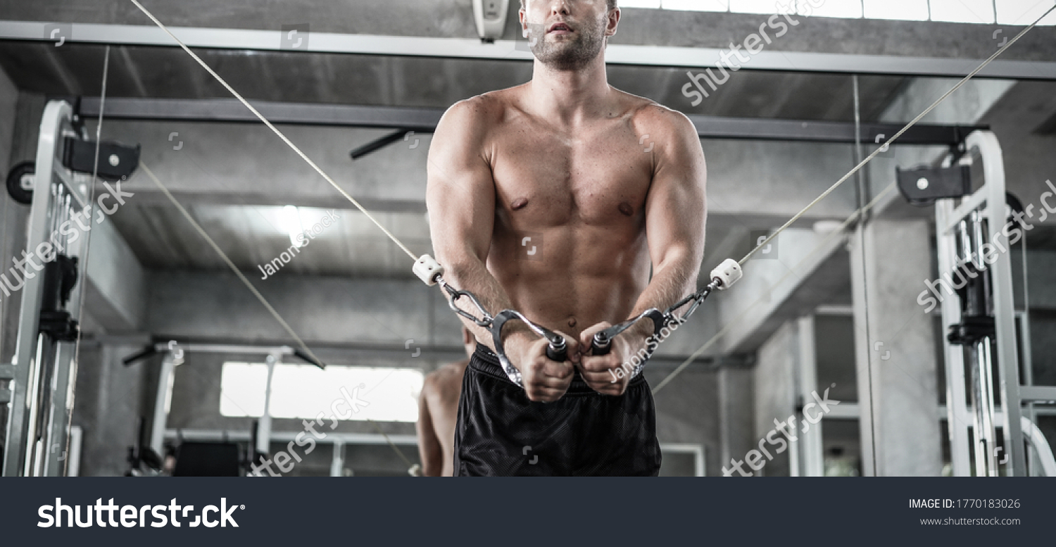 athletic fitness man doing Cable Tower Pulling Exercises Fitness ...