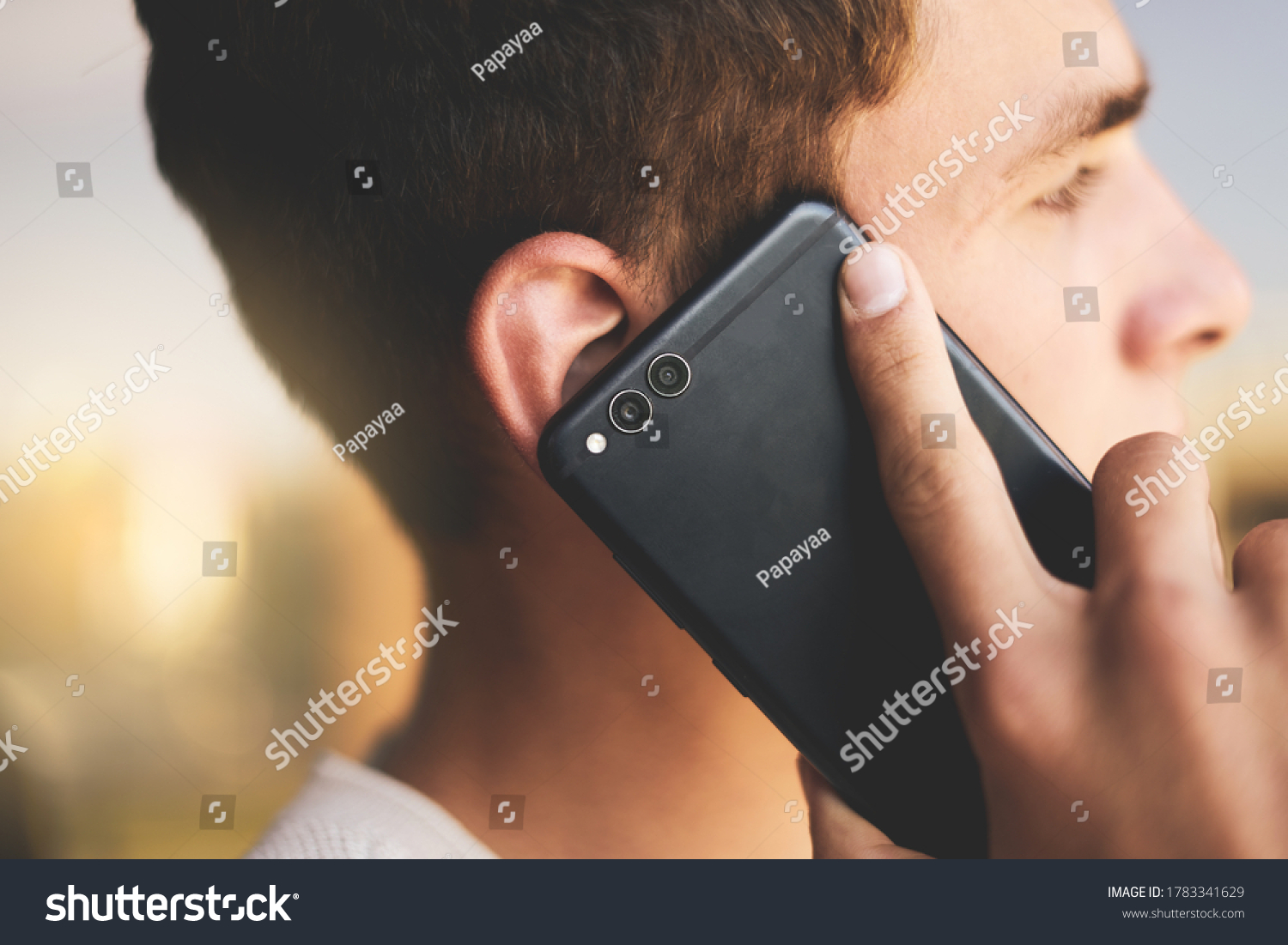 Young man holding mobile phone using smartphone making call talking on ...