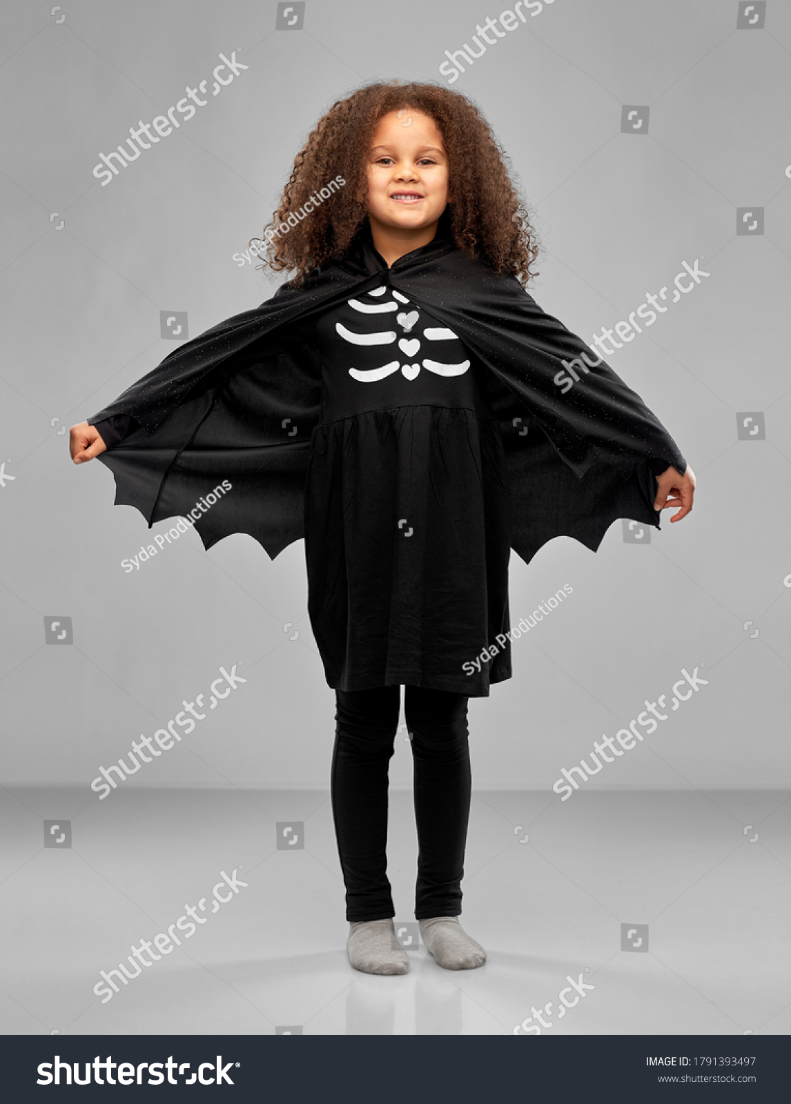 halloween holiday and childhood concept - smiling african american girl ...