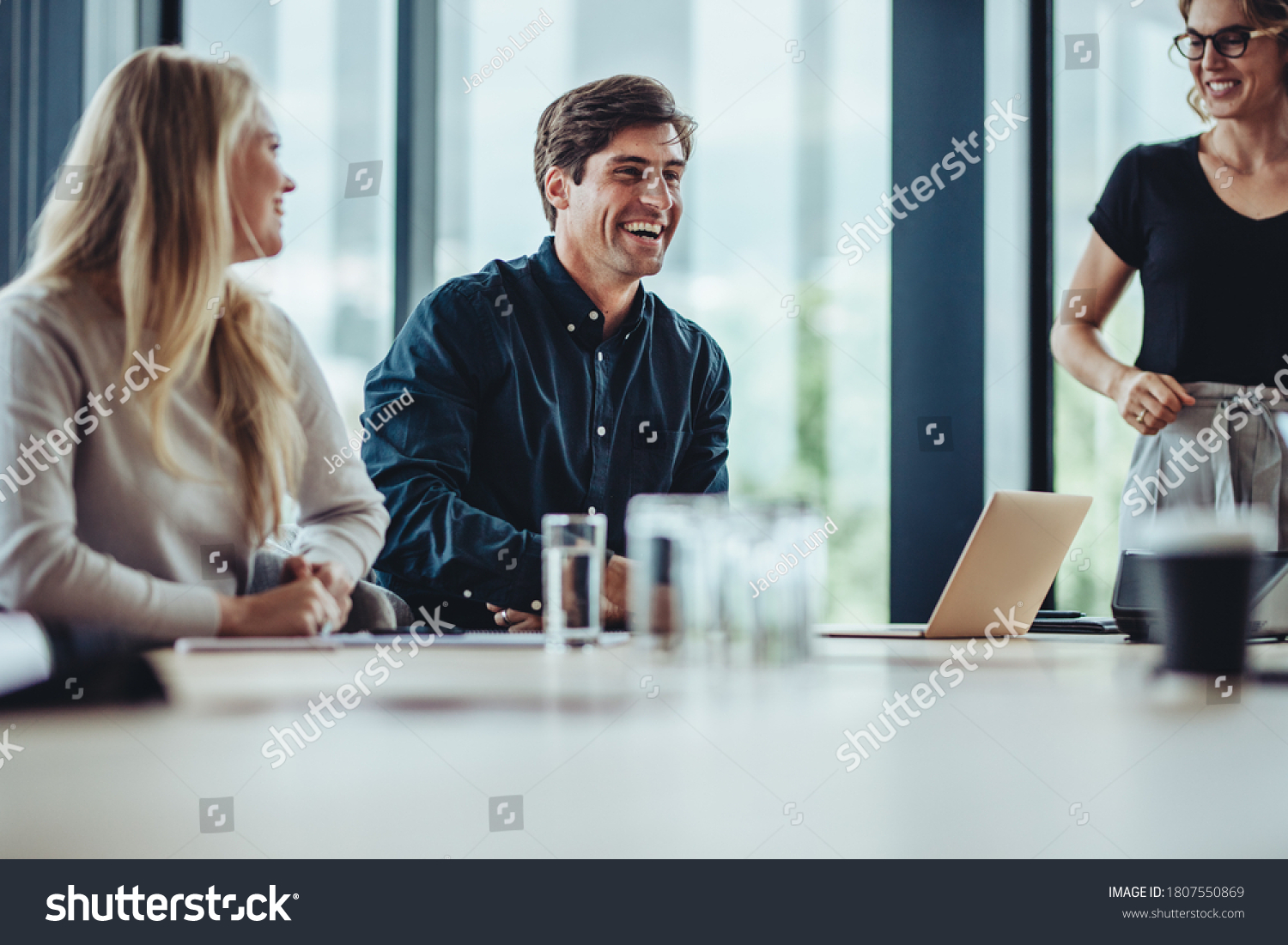 Businessman smiling during a meeting. Business people smiling after a ...