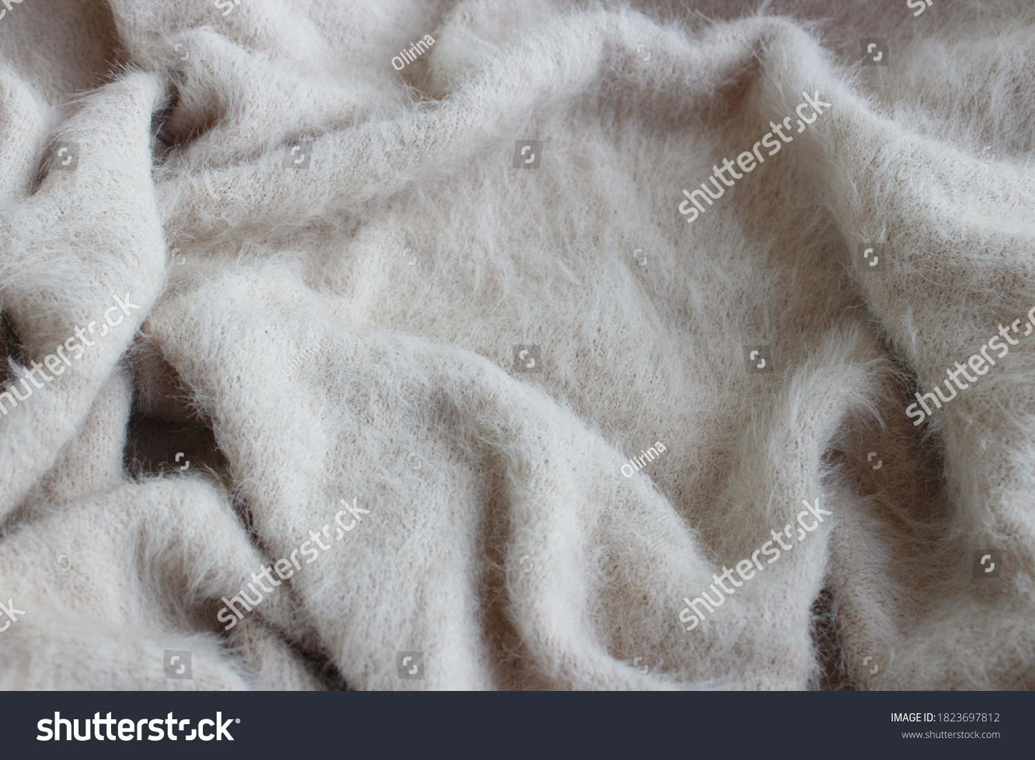 Gray fleecy wool fabric with pleats close-up. Cozy blanket scarf with ...