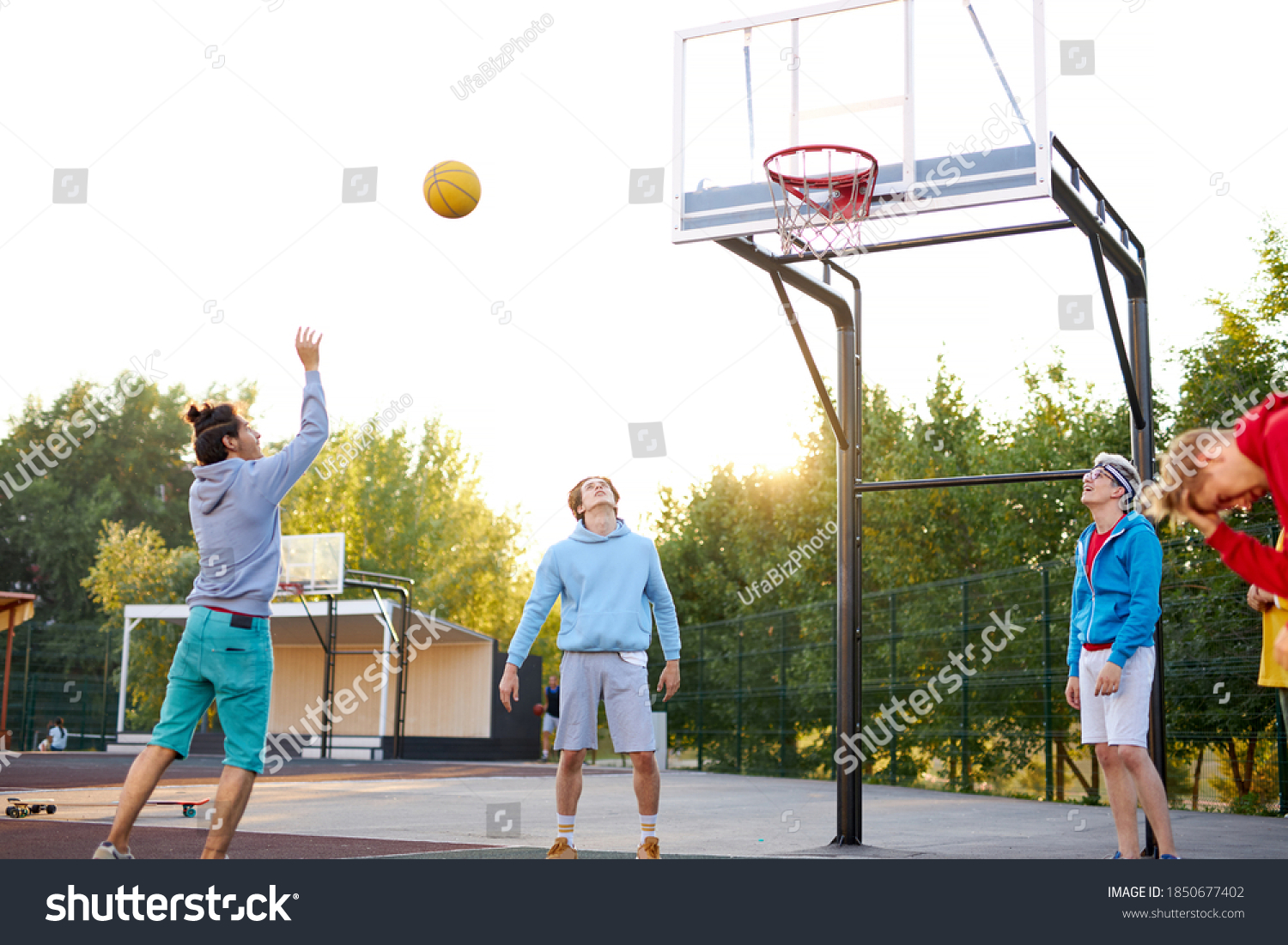 catch it. positive delighted teenager boys play basketball want to win ...