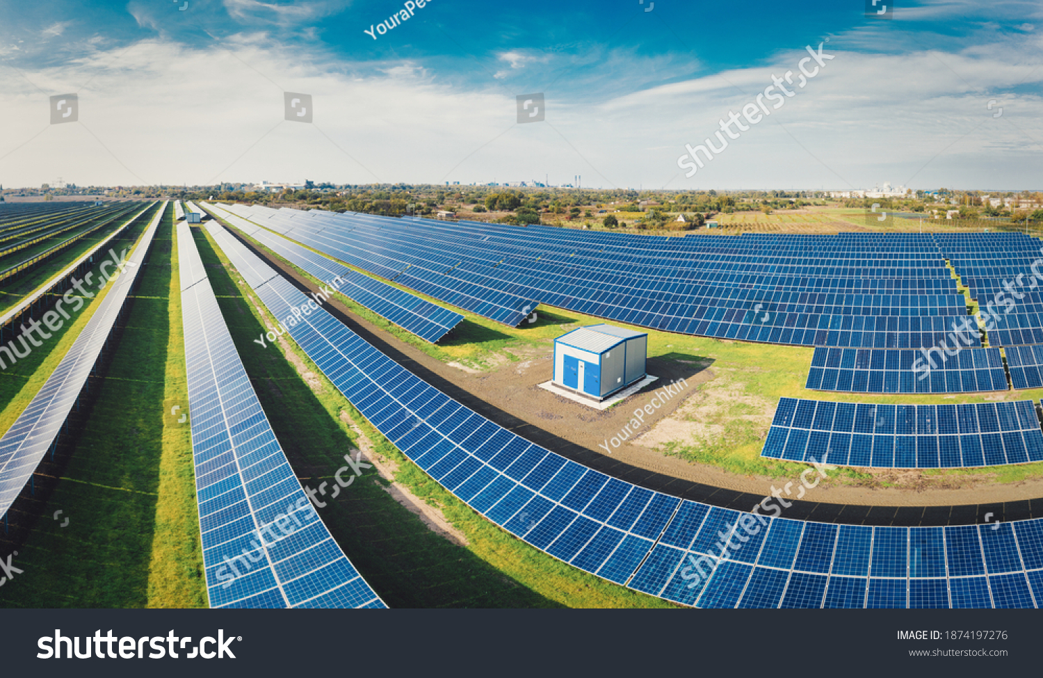 Huge solar power plant to use solar energy in a picturesque green field ...
