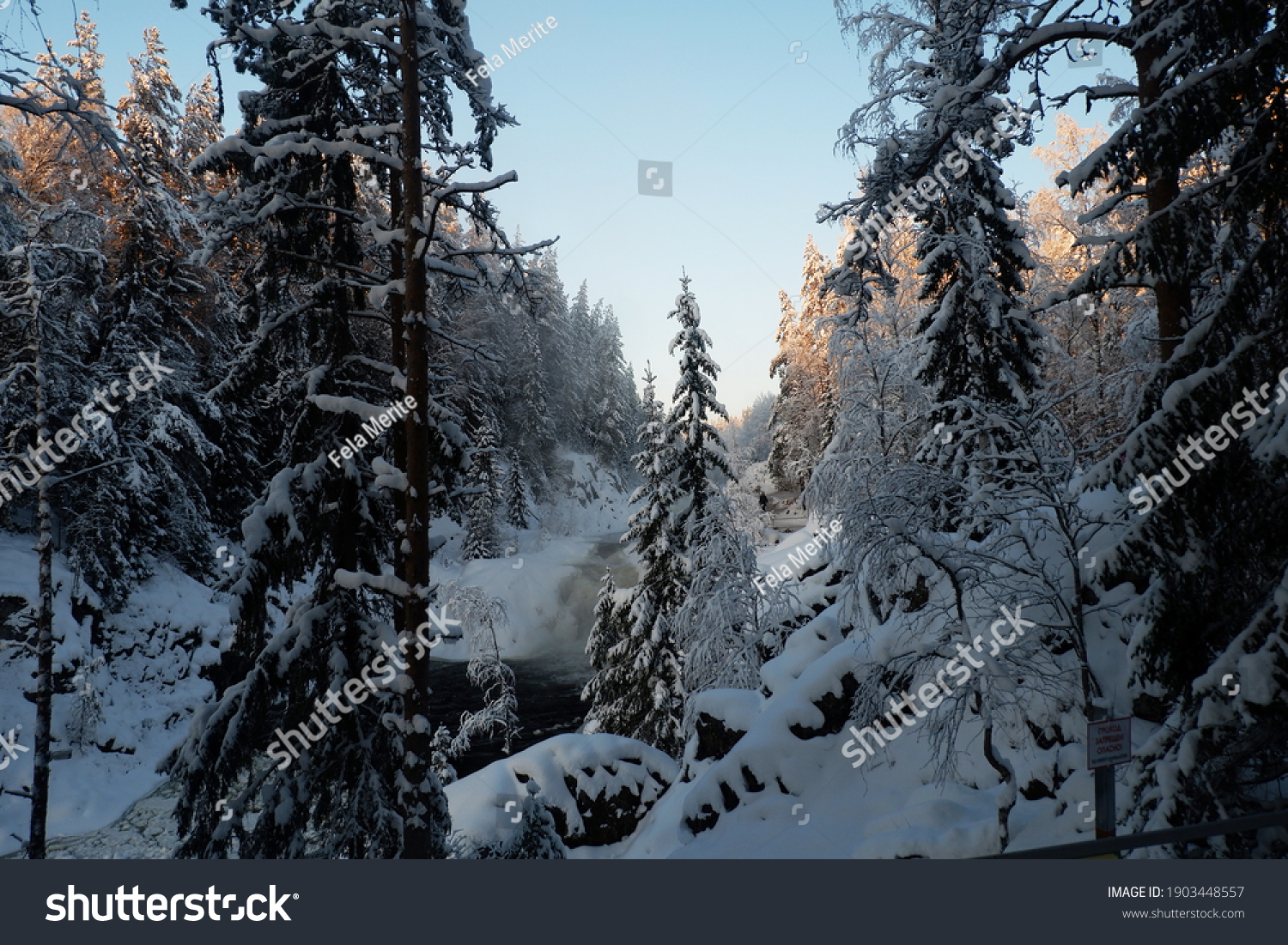 Beautiful winter Karelian landscape of the Kivach waterfall on the Suna River with snow-covered ...
