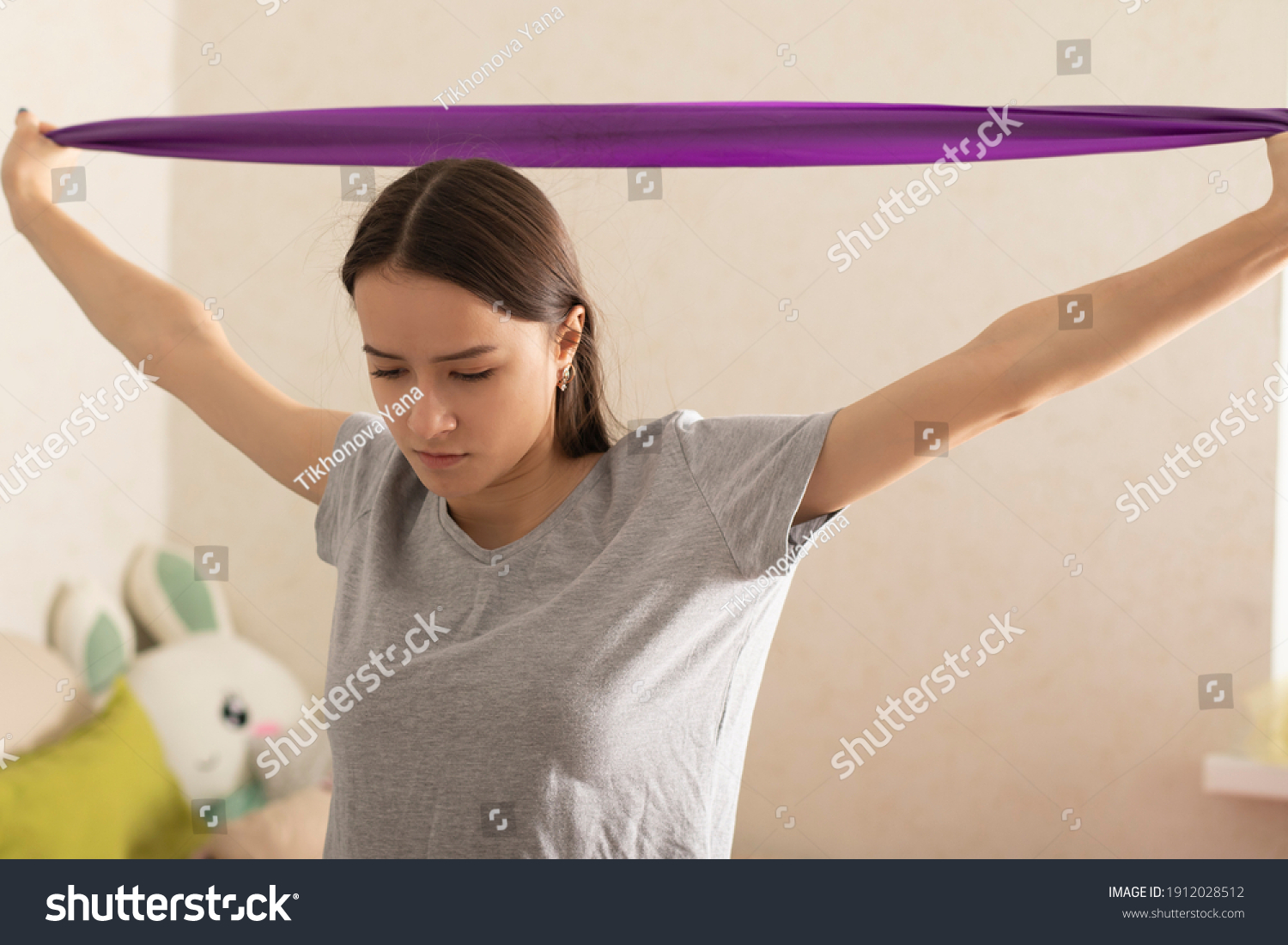 Sports at home during quarantine the girl is engaged in fitness with an ...