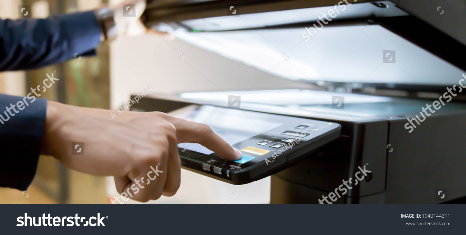 Close-up bussiness man Hand press button on panel of printer printer ...