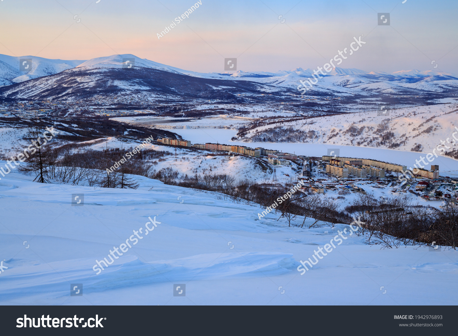 Evening landscape with the town among the mountains. Top view of the ...