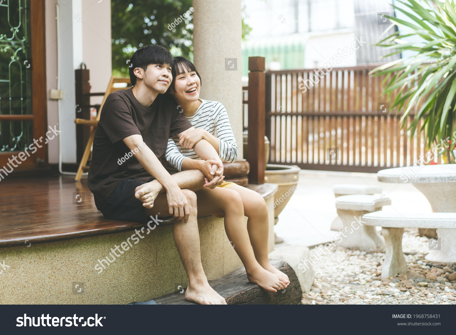 Young adult asian lover couple together living at home concept. Sitting at garden terrace ...