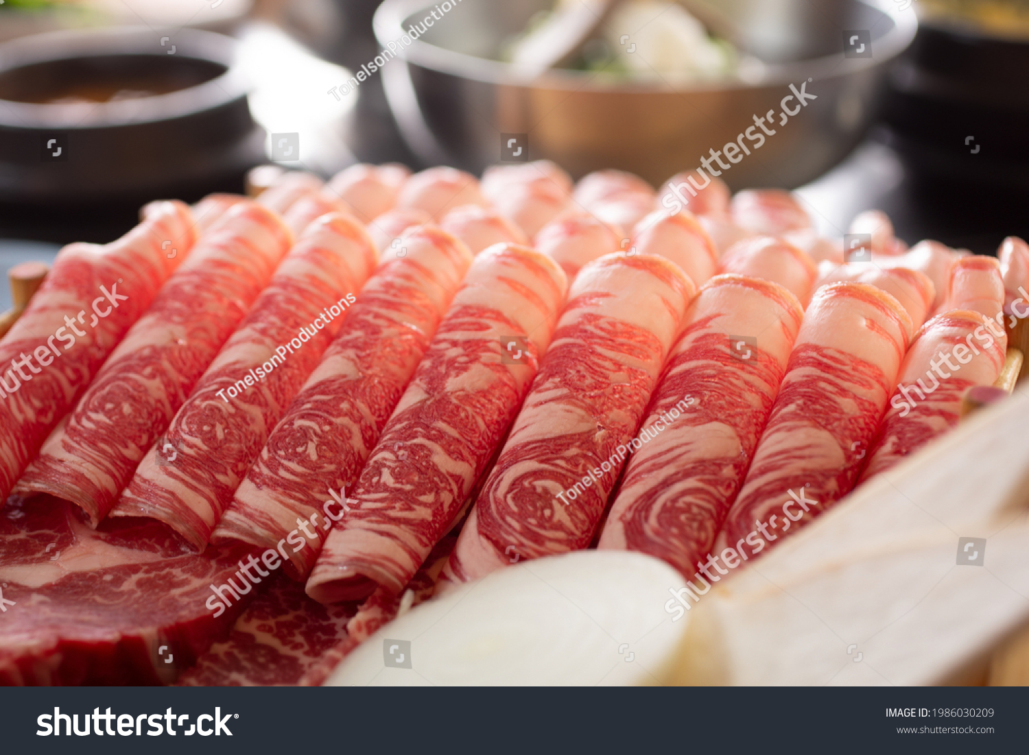 A closeup view of a tray of raw thinly sliced beef seen at a Korean BBQ ...